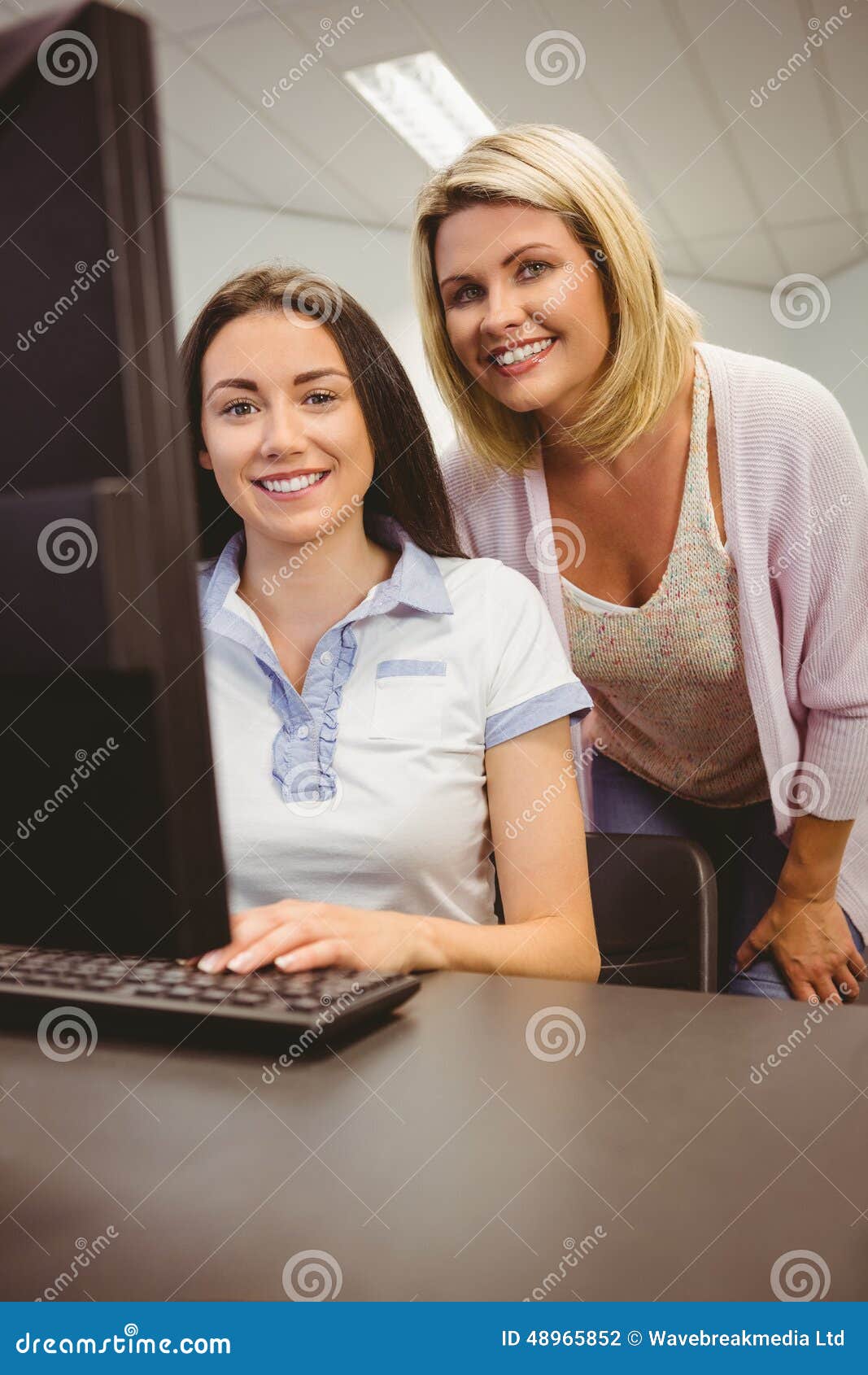 Smiling Teacher and Student Behind Desk at Computer Stock Photo - Image ...