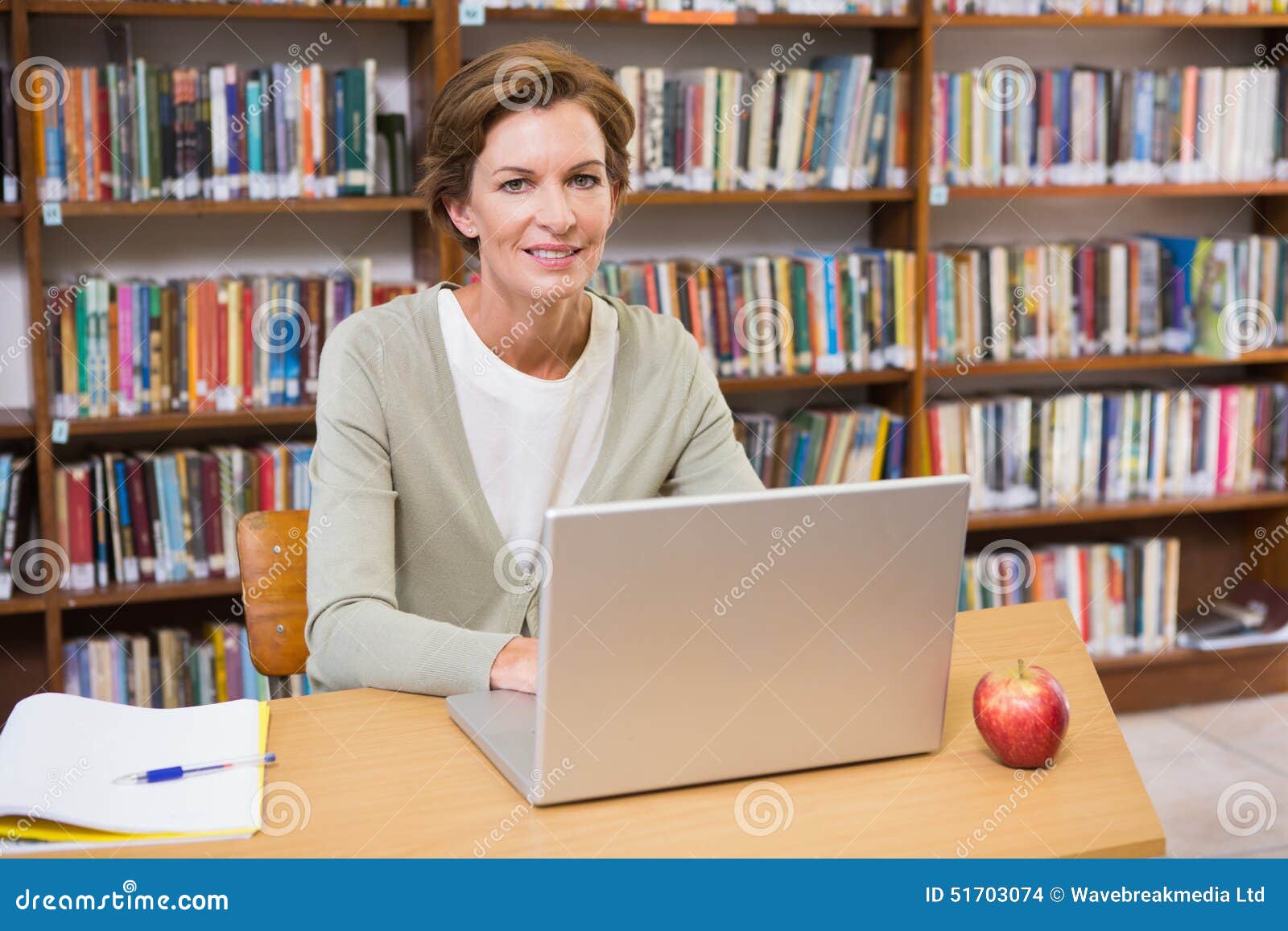 Smiling Teacher Using Laptop at a Desk Stock Photo - Image of laptop ...