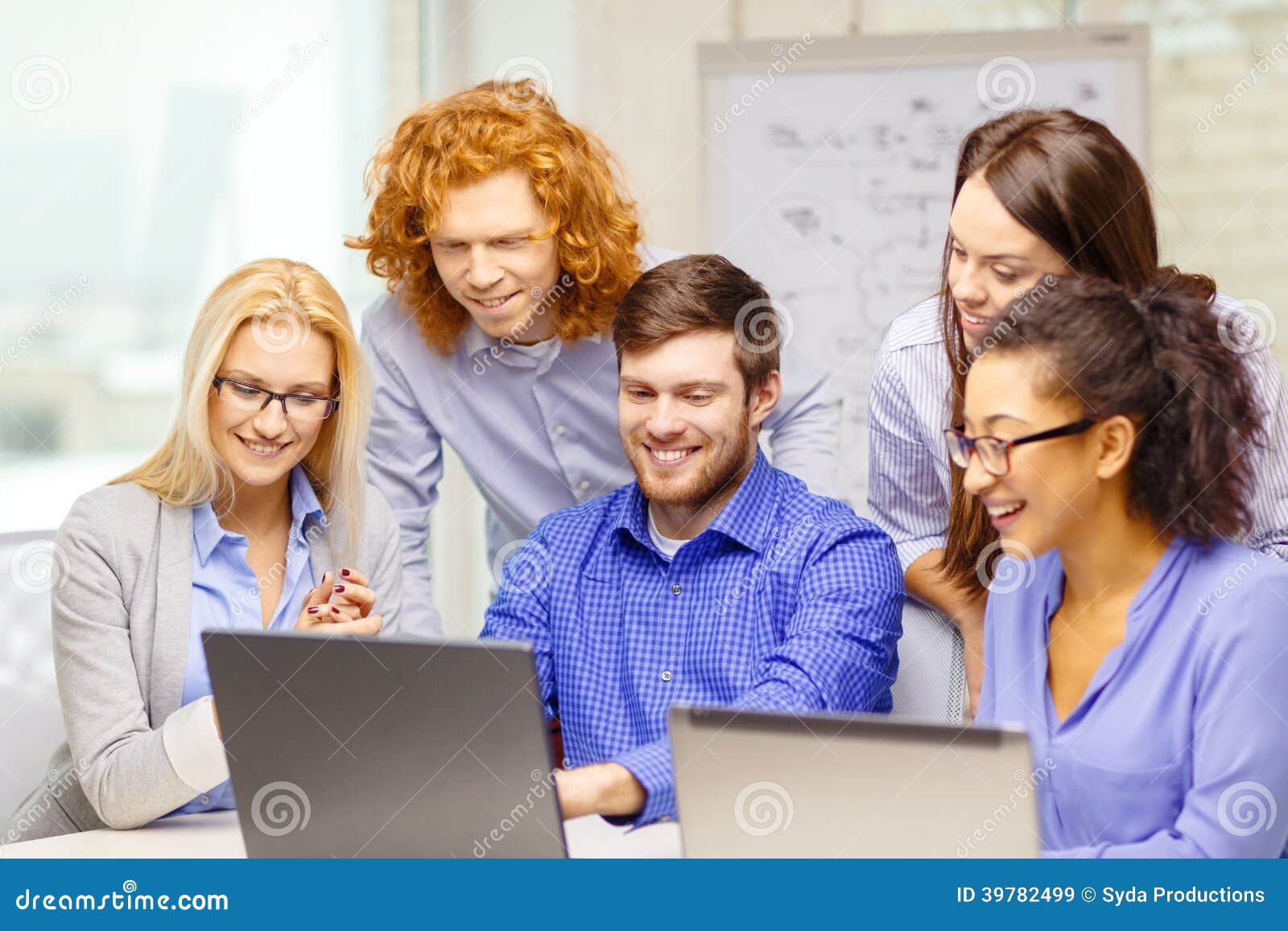 Smiling Team with Laptop Computers in Office Stock Image - Image of ...