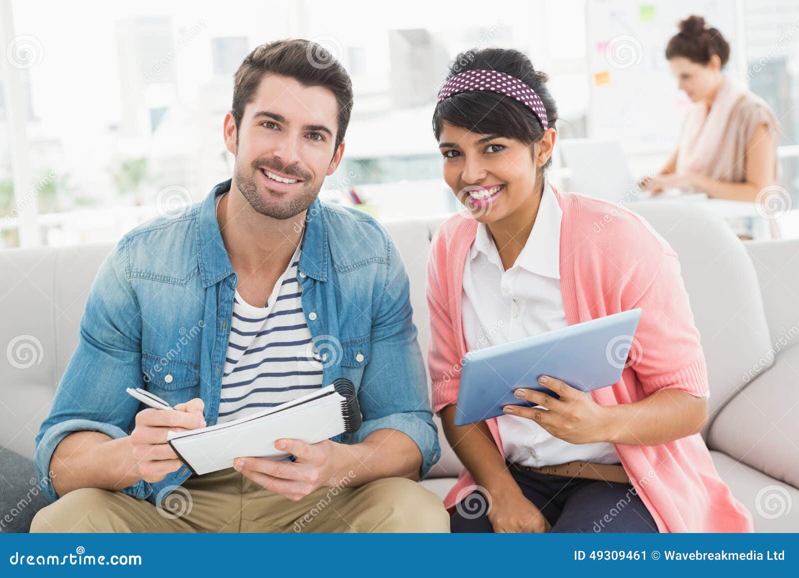 Smiling Teamwork with Notebook and Tablet on Couch Stock Image - Image ...