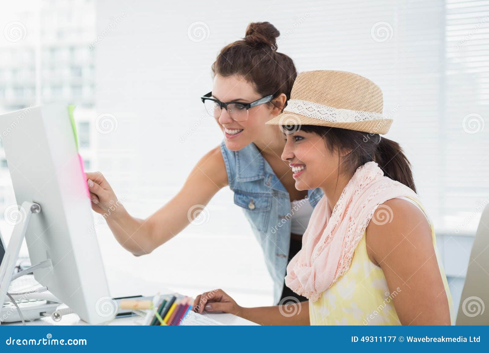 Smiling Teamwork Pointing Computer at Desk Stock Image - Image of happy ...
