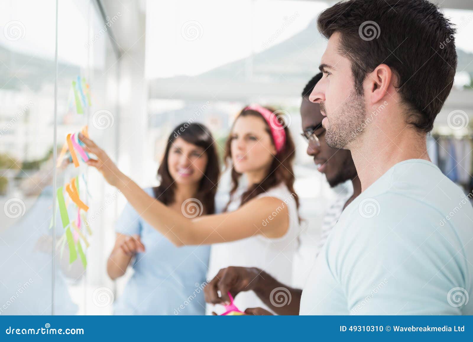 Smiling Teamwork Reading Sticky Notes Stock Photo - Image of design ...