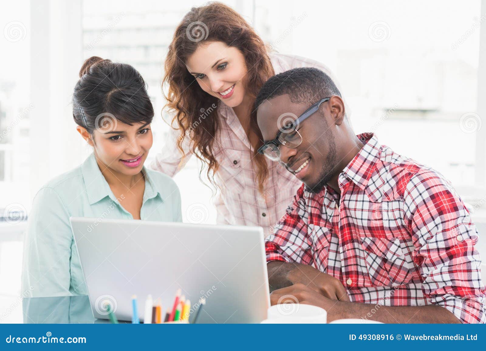 Smiling Teamwork Using Laptop Together Stock Photo - Image of design ...
