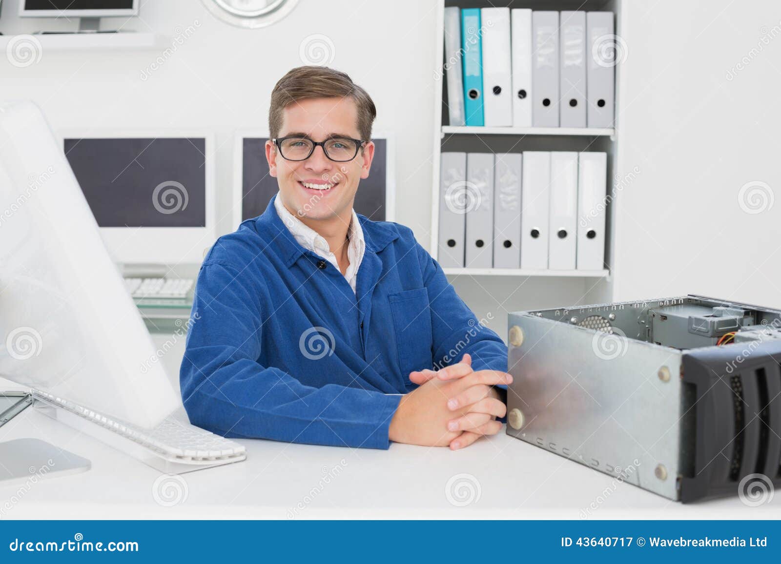 Smiling Technician Sitting at Desk Stock Image - Image of technician ...