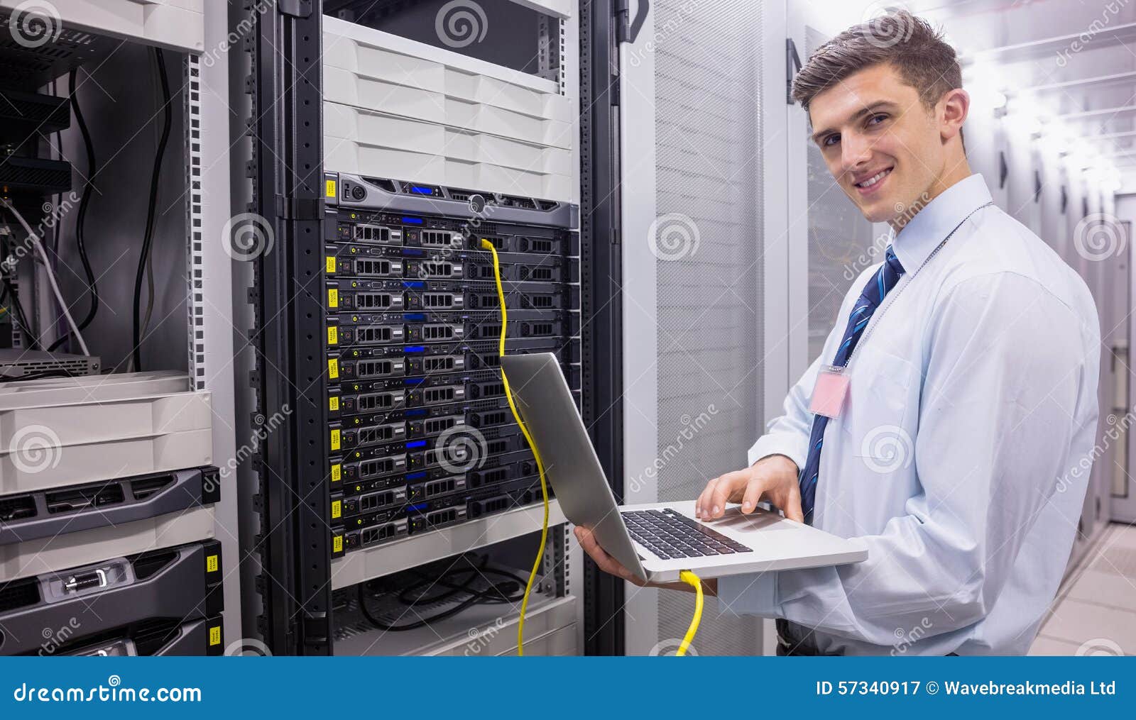 Smiling Technician Using Laptop while Analysing Server Stock Image ...