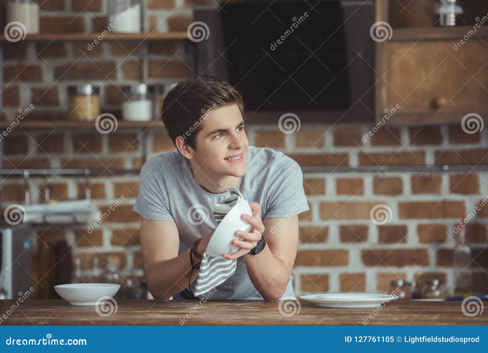 Smiling Teen Boy Cleaning Dinnerware with Towel Stock Image - Image of ...