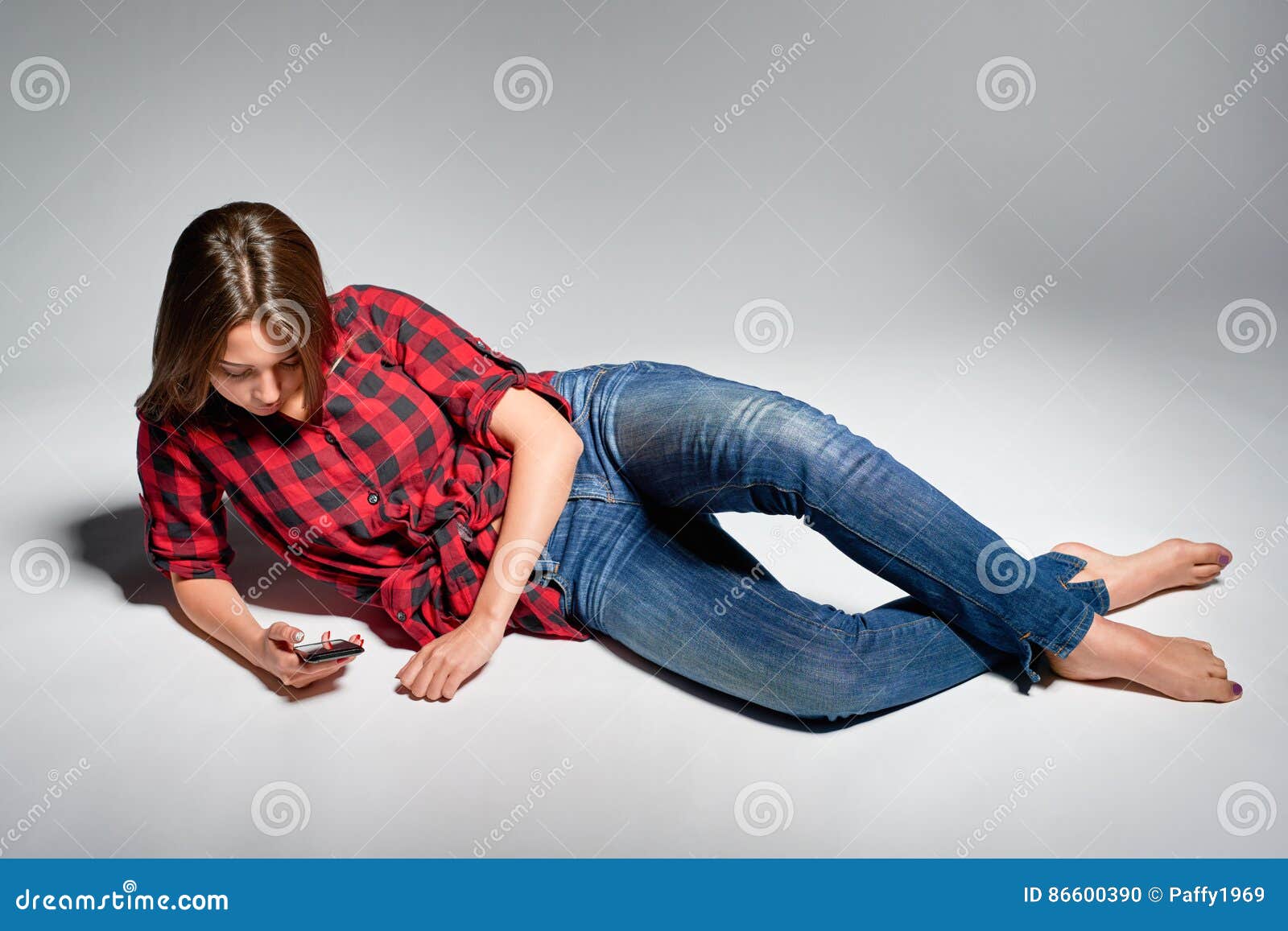 Smiling Teen Girl Sitting Barefooted At Floor Smiling At Camera Stock