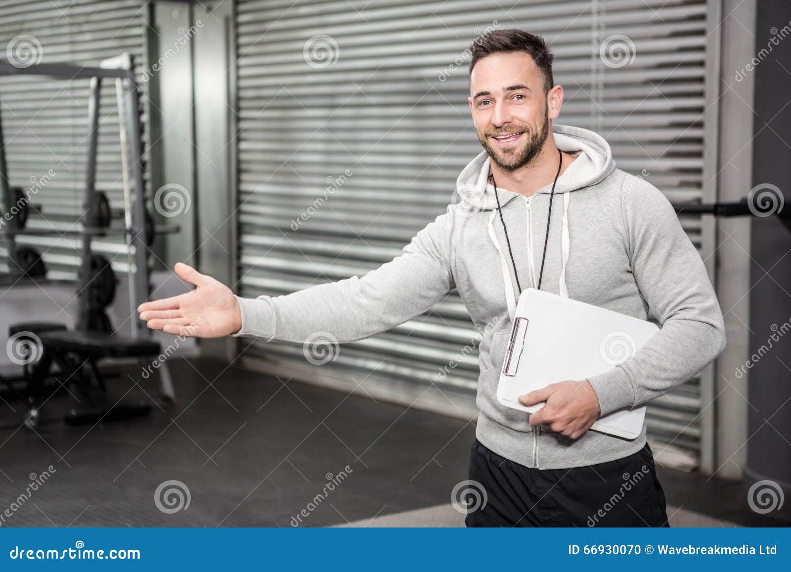 Smiling Trainer Showing Gym To Camera Stock Photo - Image of male ...