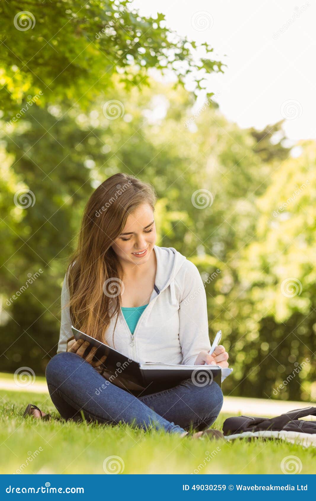 Smiling University Student Sitting and Writing on Notepad Stock Image ...