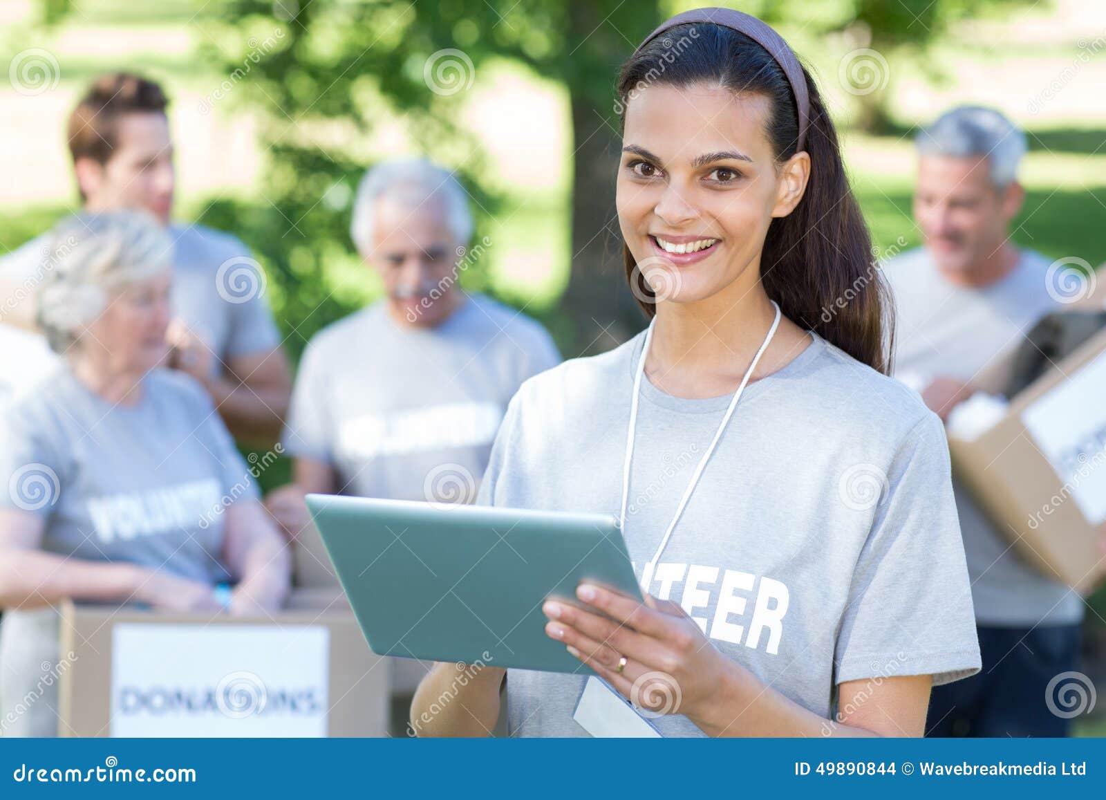 Smiling Volunteer Brunette Using Tablet Pc Stock Photo - Image of care ...