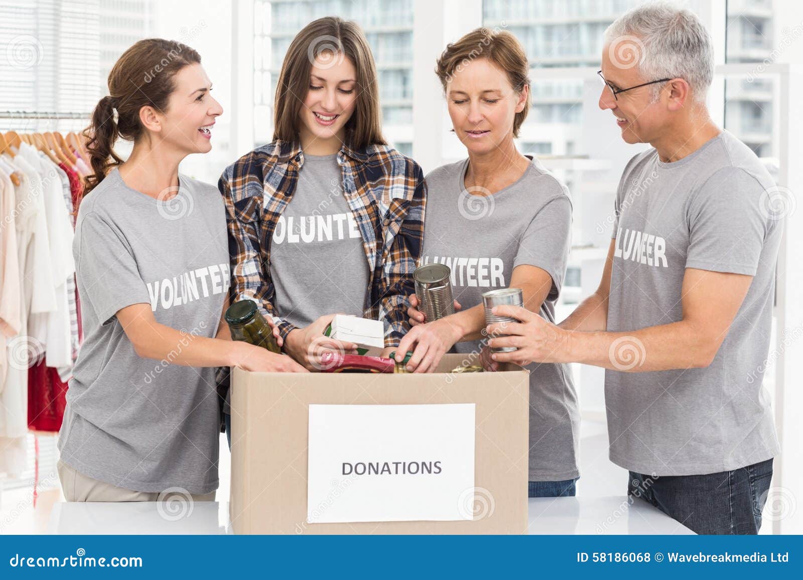 Smiling Volunteers Sorting Donation Box Stock Photo - Image of ...