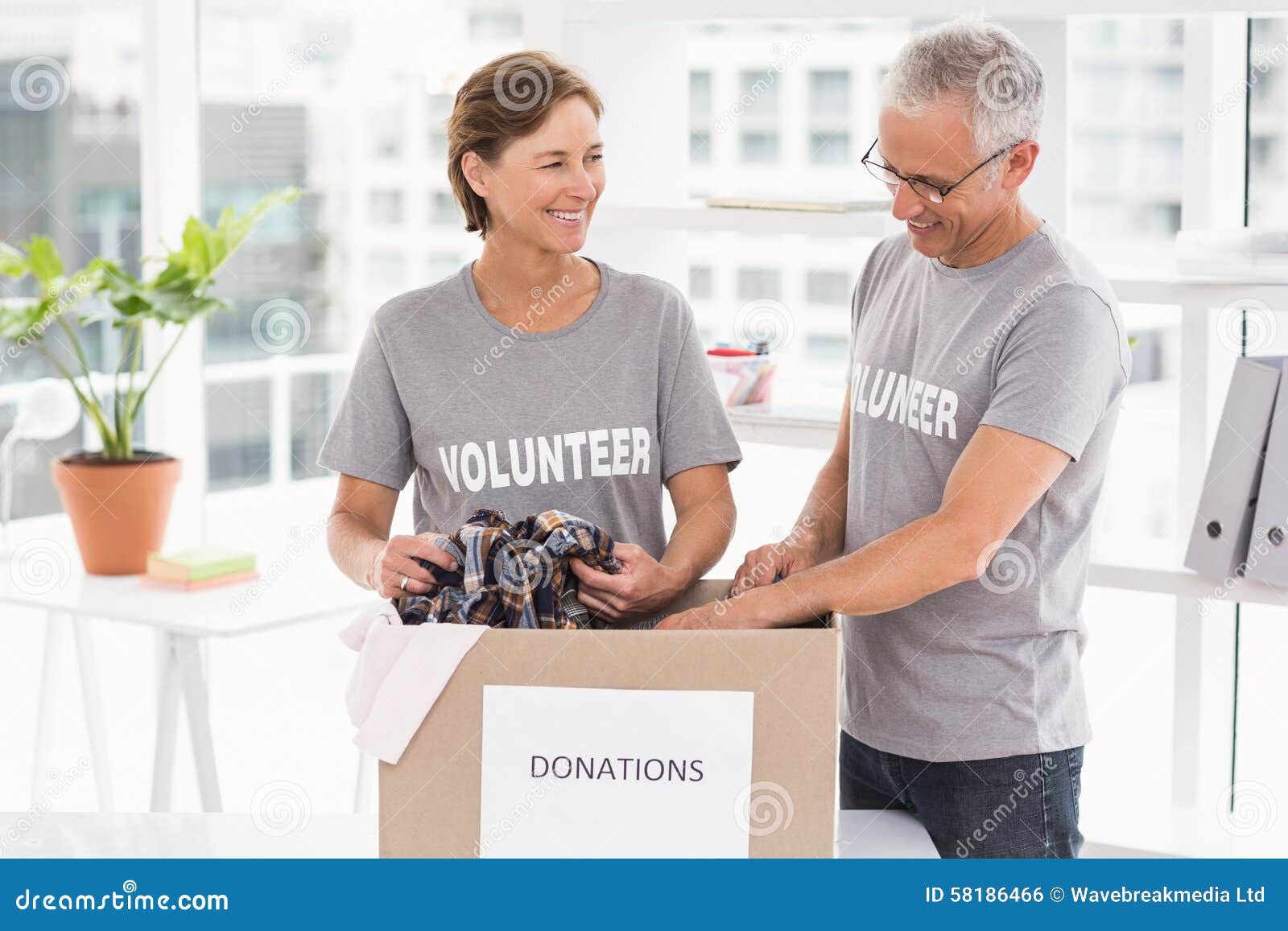 Smiling Volunteers Sorting Donation Box Stock Photo - Image of group ...