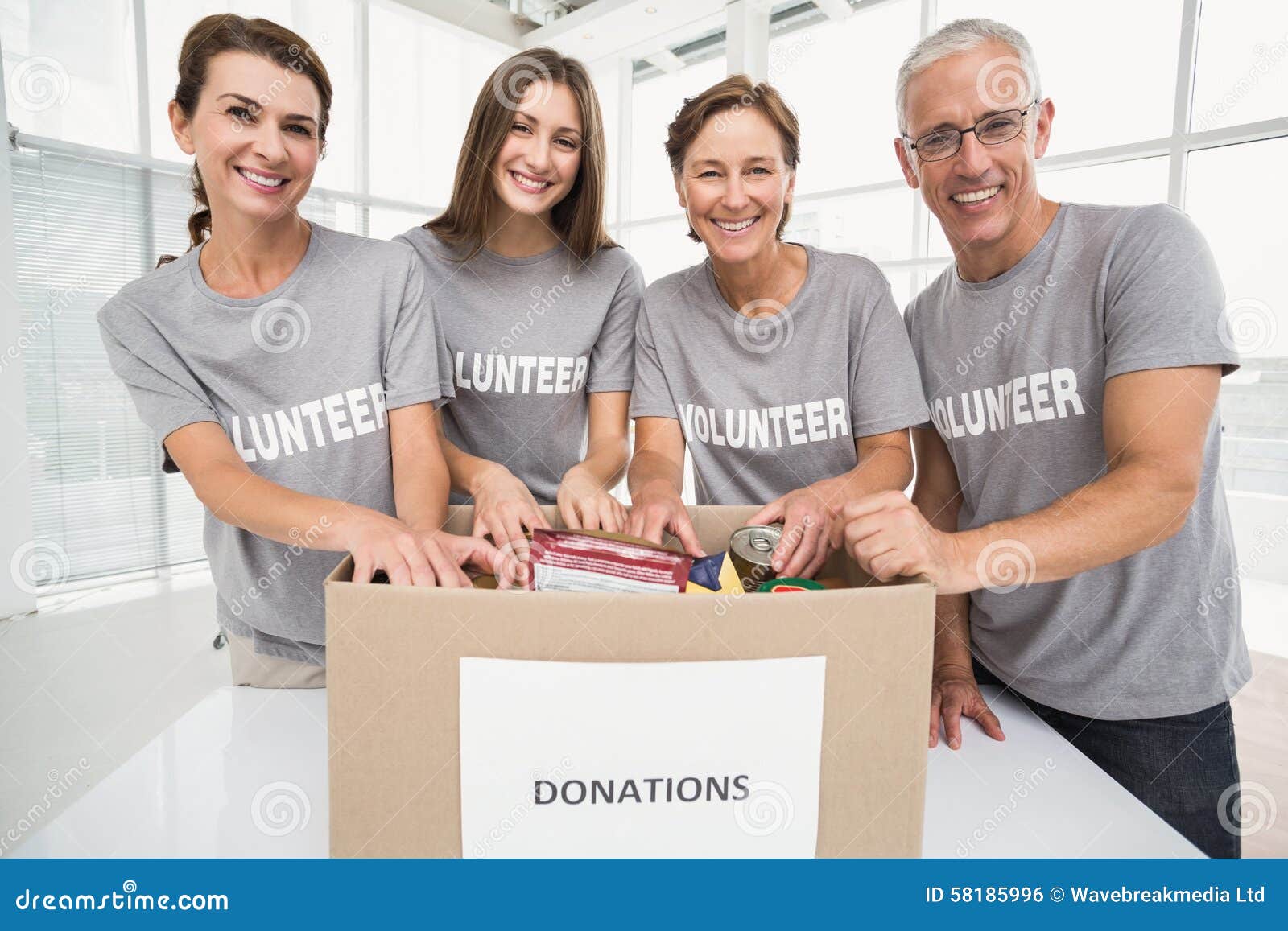 Smiling Volunteers Sorting Donation Box Stock Photo - Image of ...