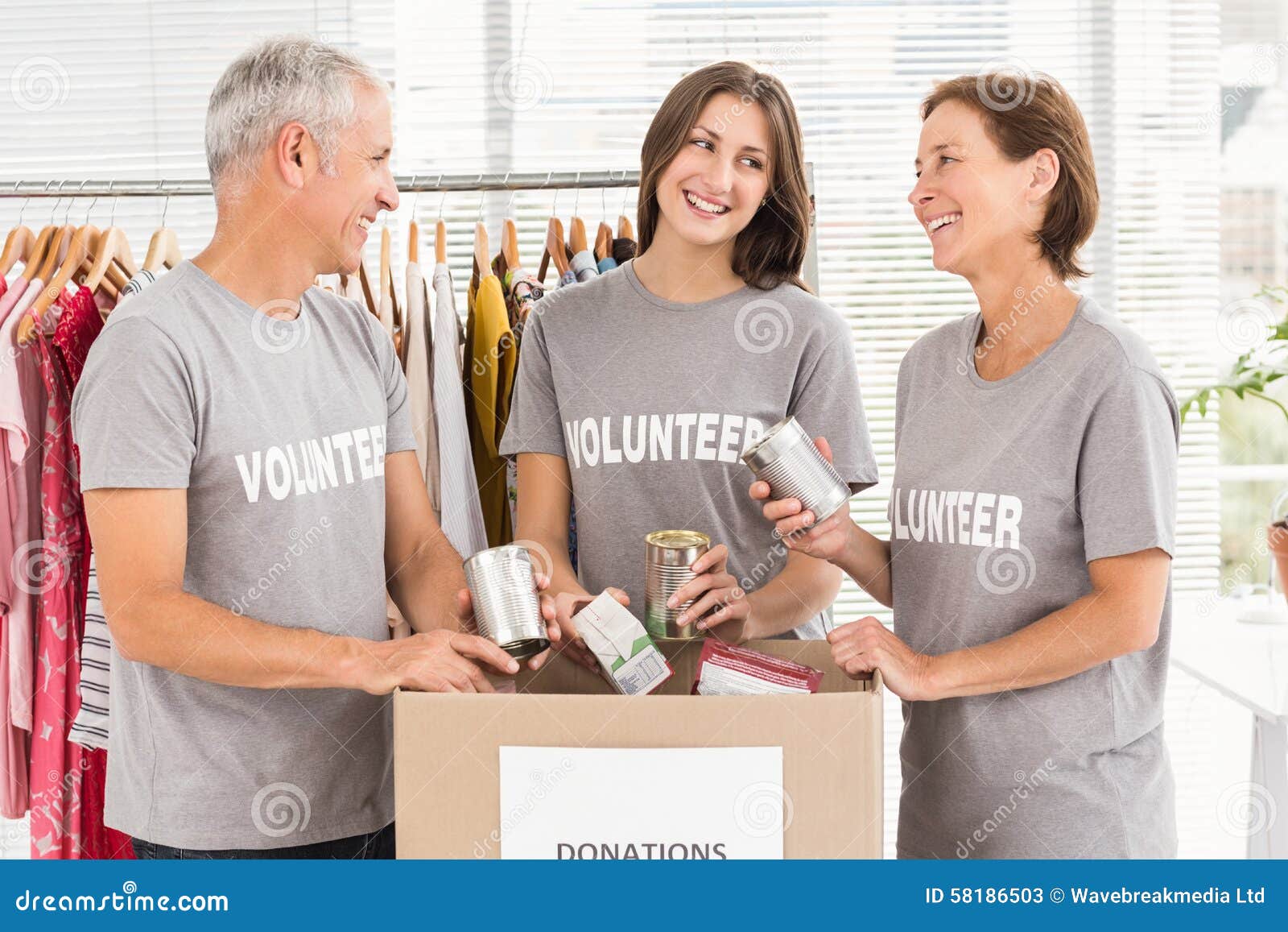 Smiling Volunteers Sorting Donations Stock Image - Image of colleagues ...