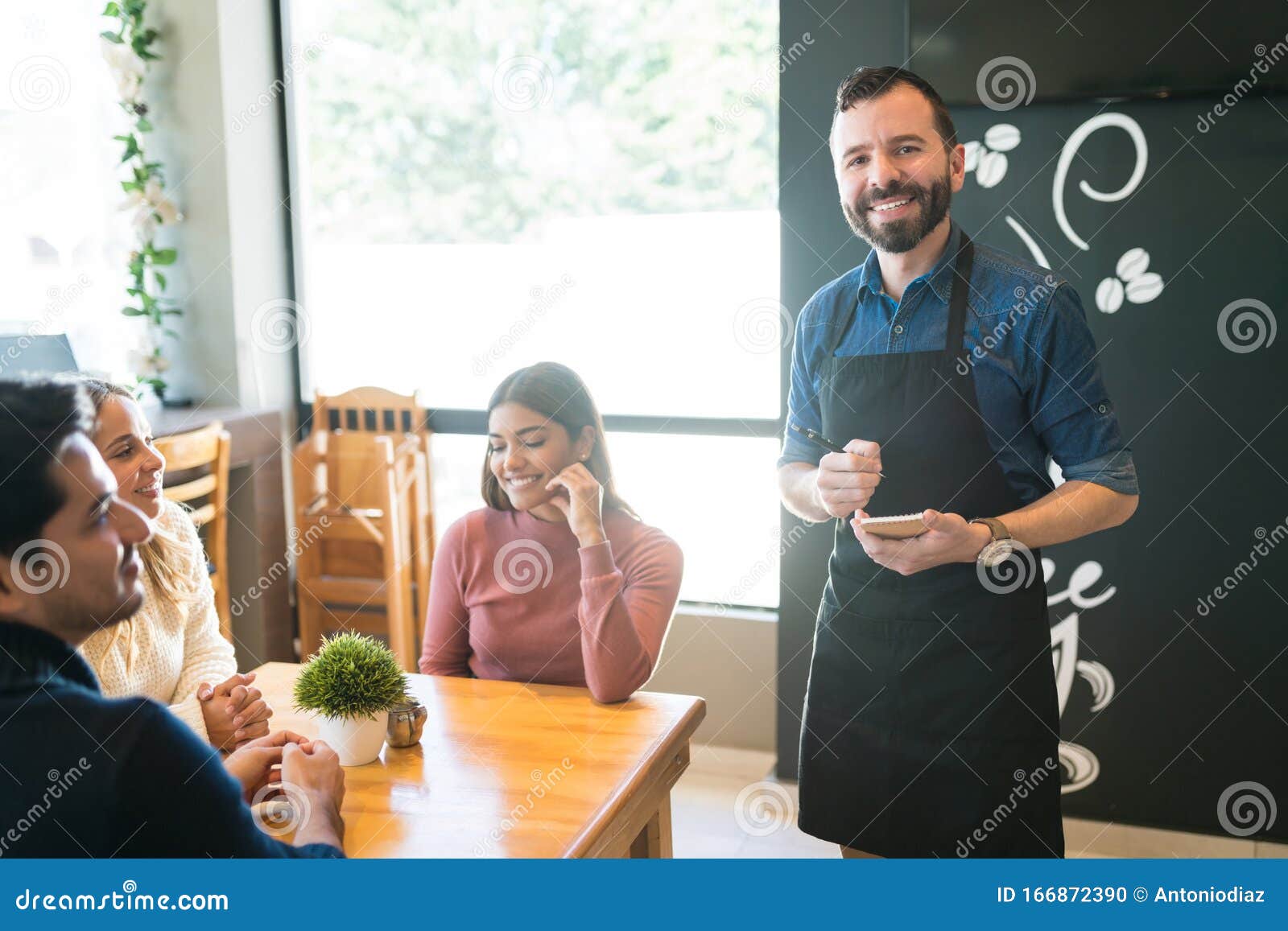 Smiling Waiter with Customers at Cafe Stock Photo - Image of women ...