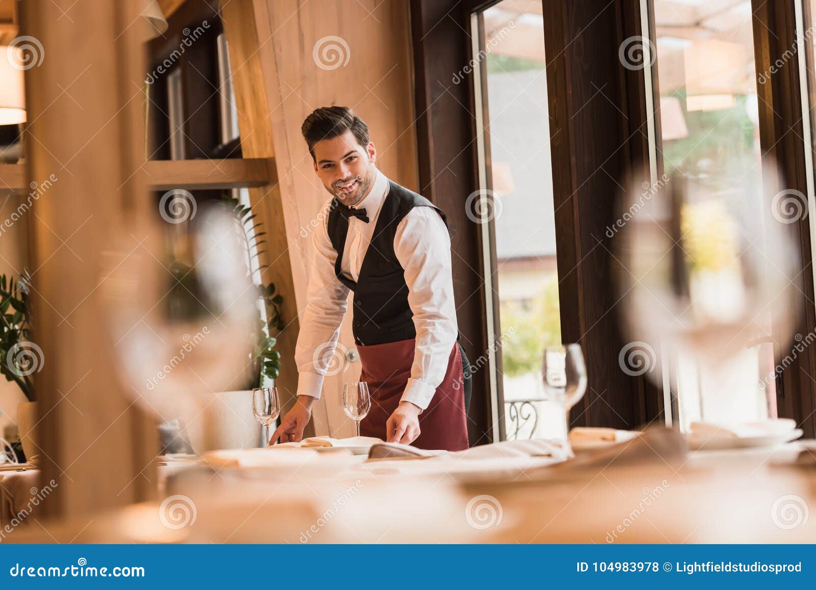 Waiter serving tables stock photo. Image of cheerful - 104983978