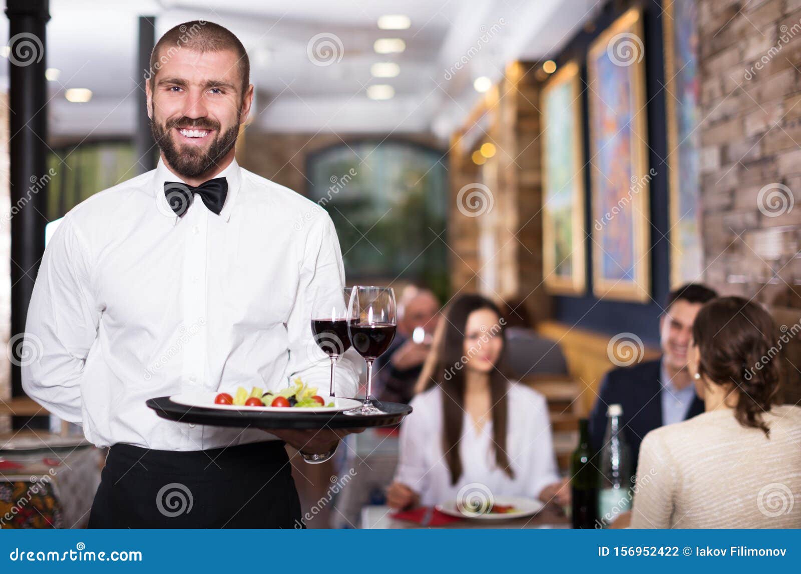 Smiling Waiter with Serving Tray in Restaurant Stock Photo - Image of ...