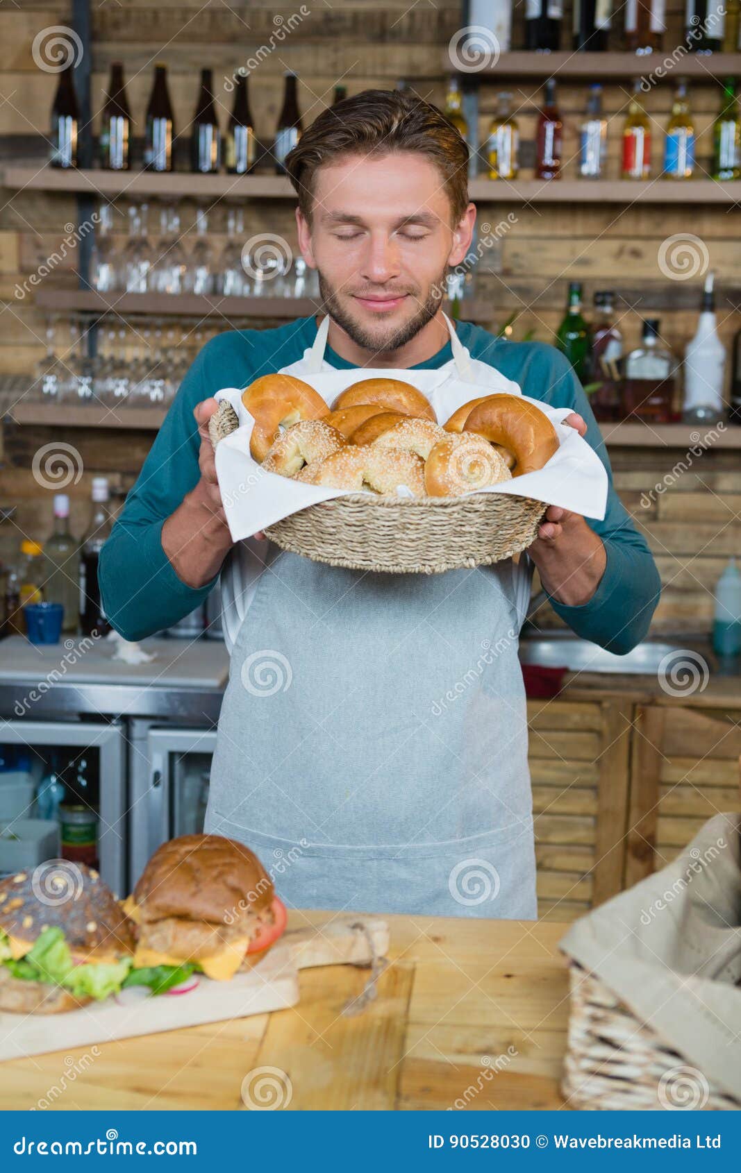 Smiling Waiter Smelling the Basket of Fresh Bread at Counter Stock ...