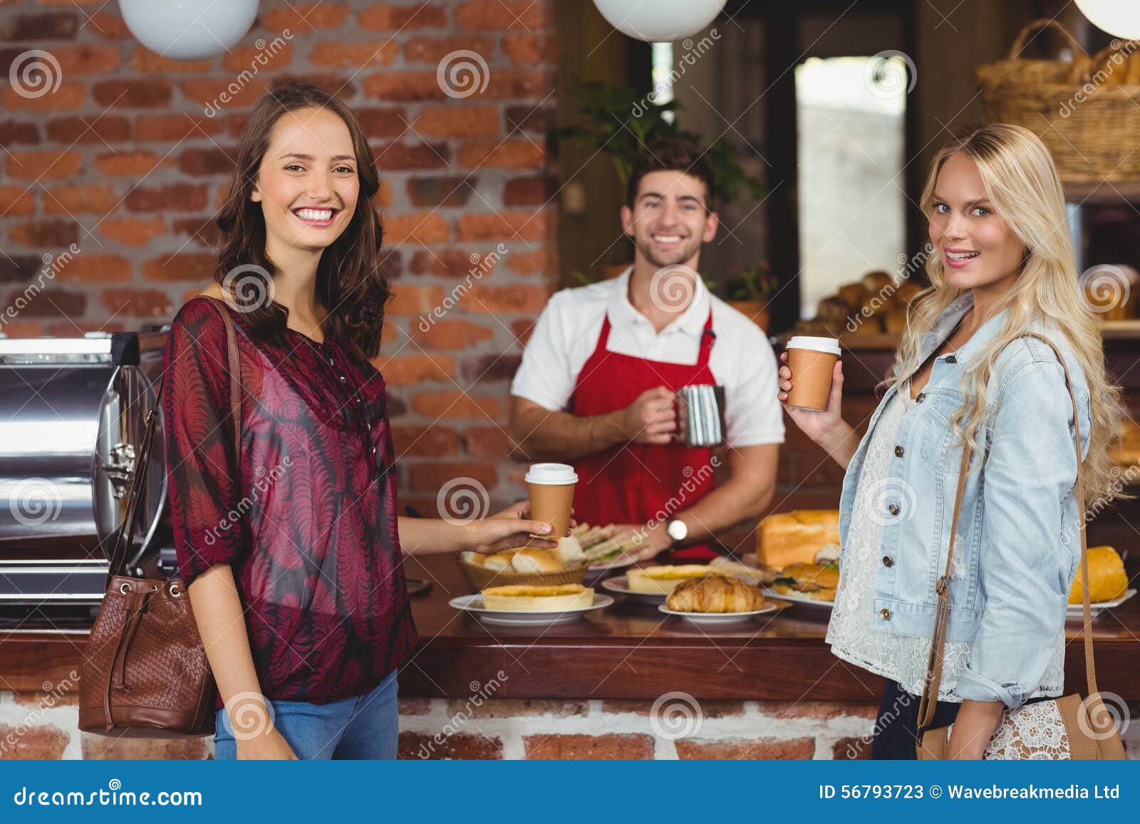 Smiling Waiter and Two Customers Looking at the Camera Stock Image ...