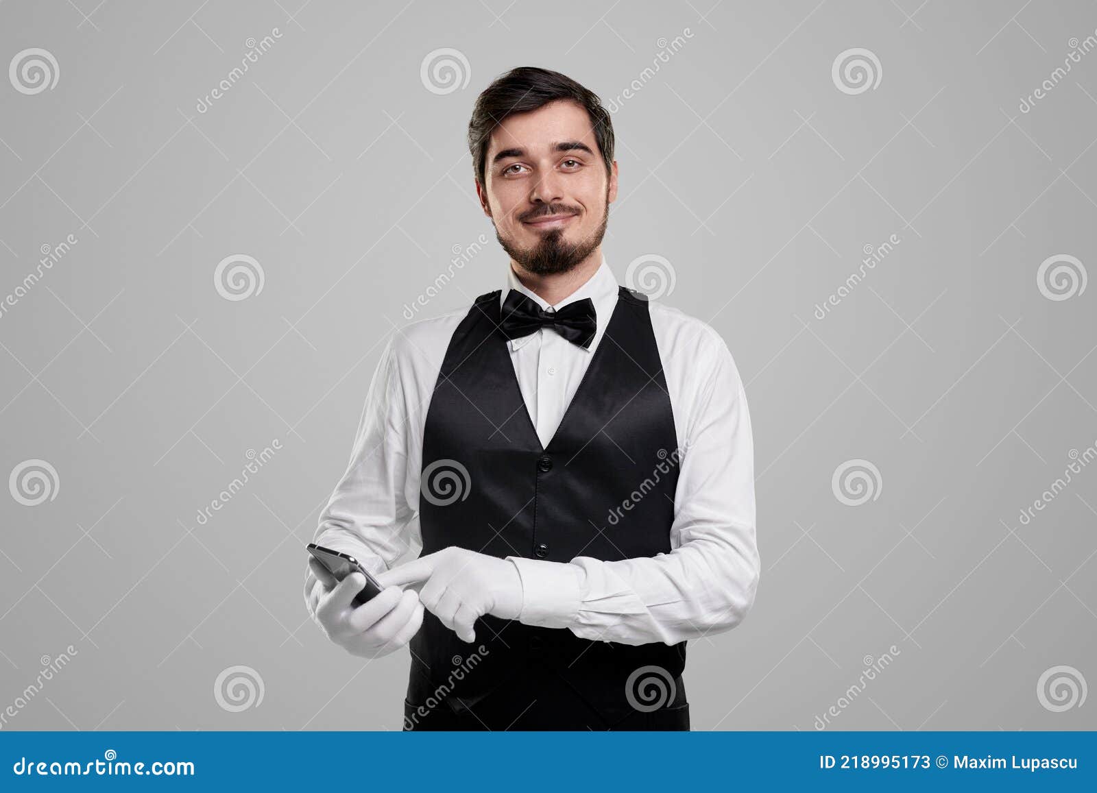 Smiling Waiter Using Smartphone in Studio Stock Image - Image of ...