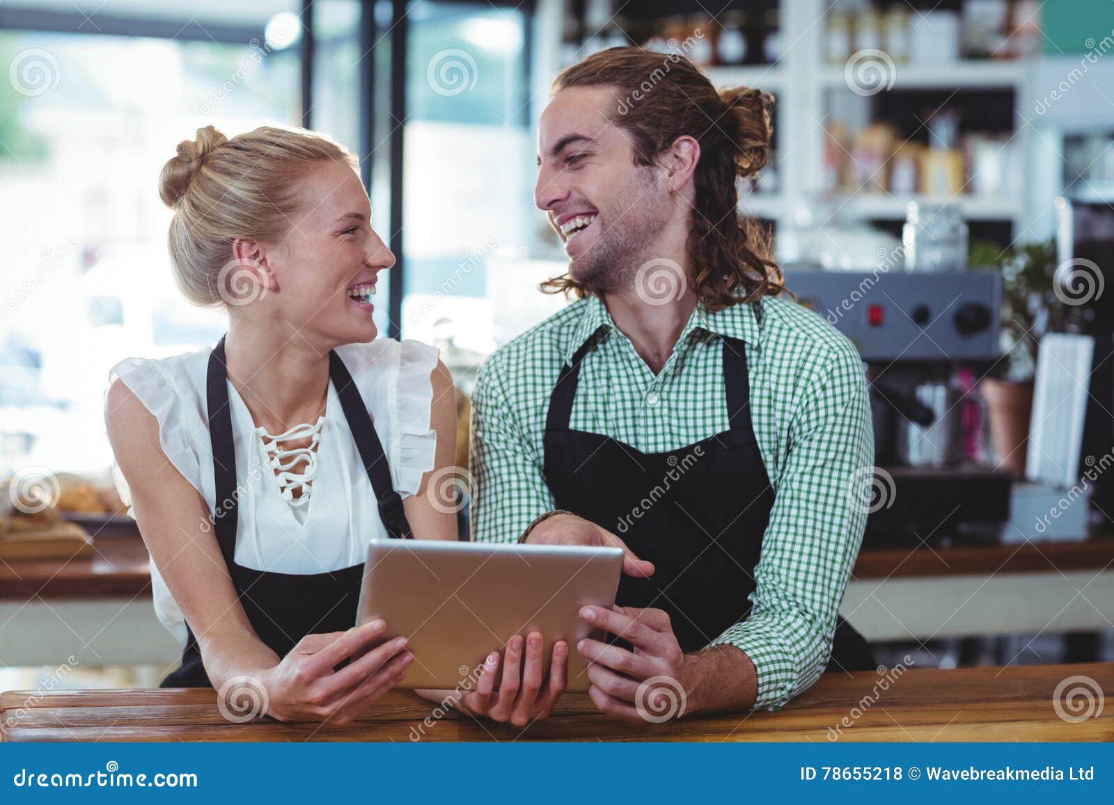 Smiling Waiter and Waitress Standing at Counter Using Digital Stock ...