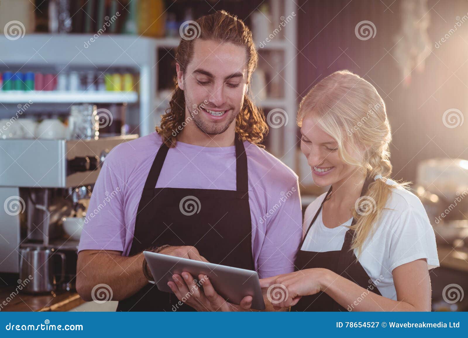 Smiling Waiter and Waitress Using Digital Tablet at Counter Stock Image ...