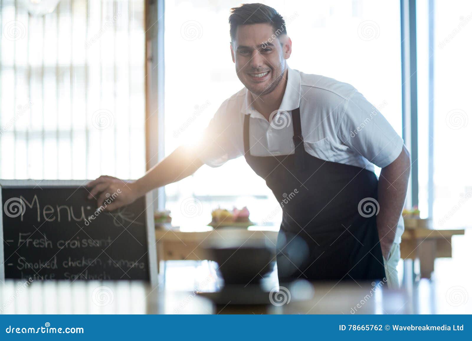 Smiling Waiter Writing on Menu Board in Cafe Stock Photo - Image of ...
