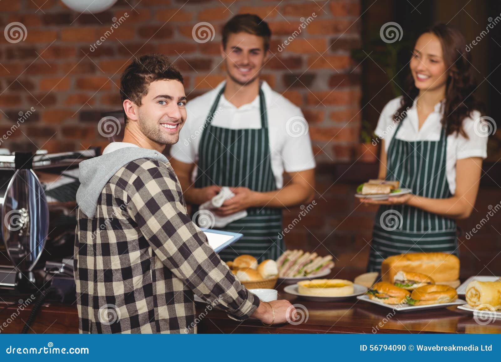 Smiling Waiters and Customer Looking at the Camera Stock Photo - Image ...