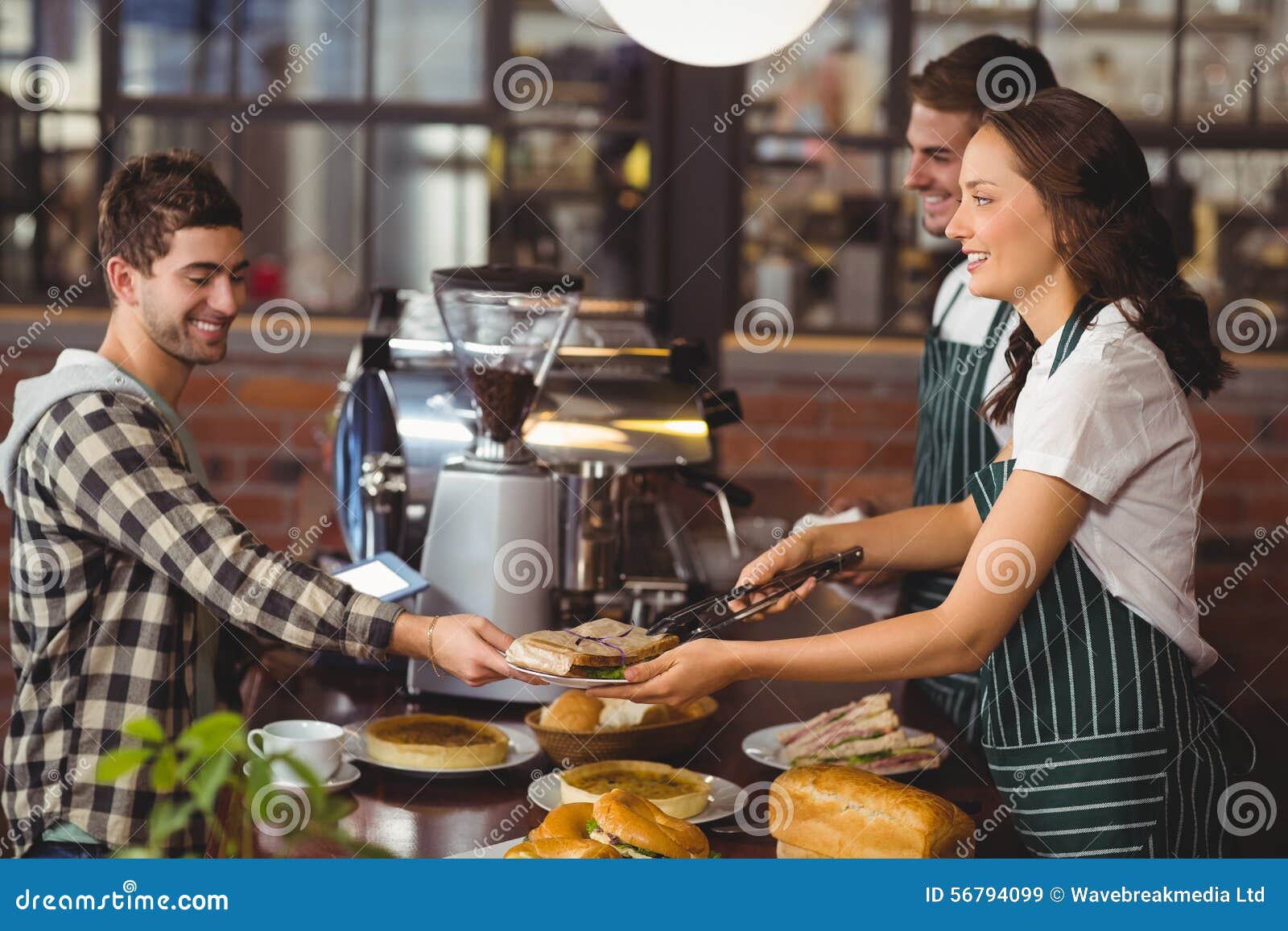 Smiling Waiters Serving a Client Stock Image - Image of handing ...