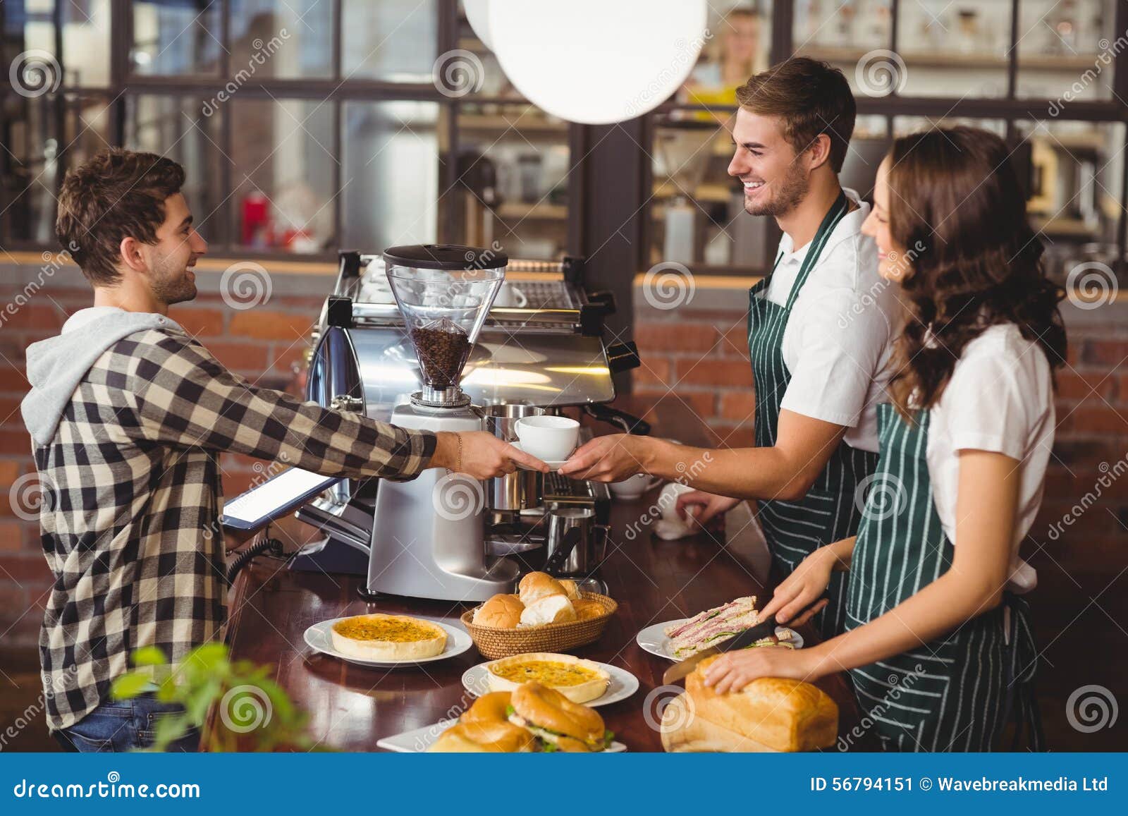 Smiling Waiters Serving a Client Stock Image - Image of colleagues ...
