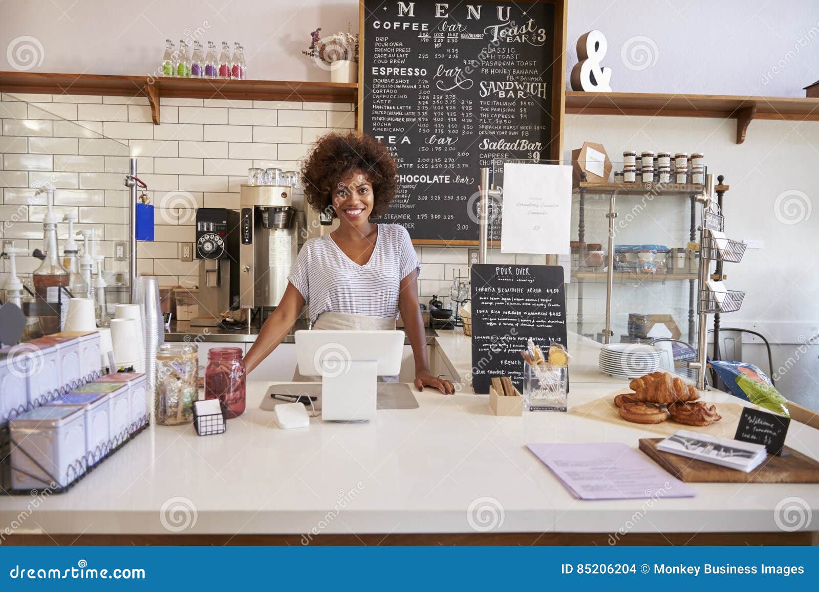 Smiling Waitress Behind the Counter at a Coffee Shop Stock Photo ...