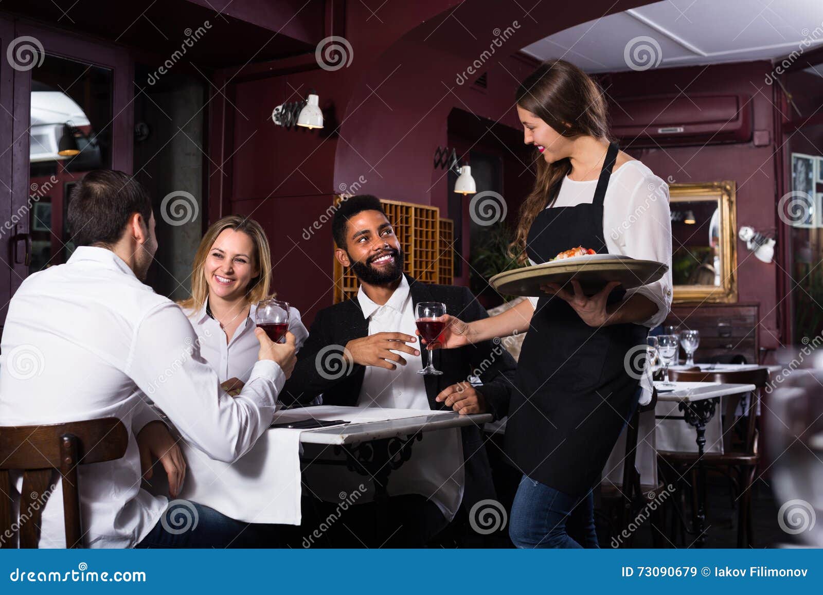 Smiling Waitress and Guests at the Table Stock Image - Image of ...