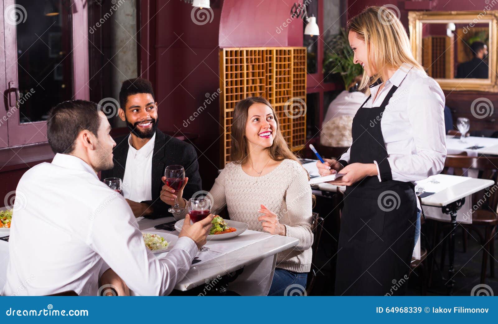Smiling Waitress and Guests at the Table Stock Image - Image of middle ...