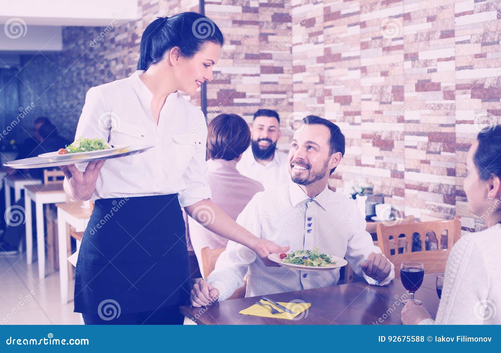 Smiling Waitress Serving Meal for Restaurant Guests Stock Photo - Image ...