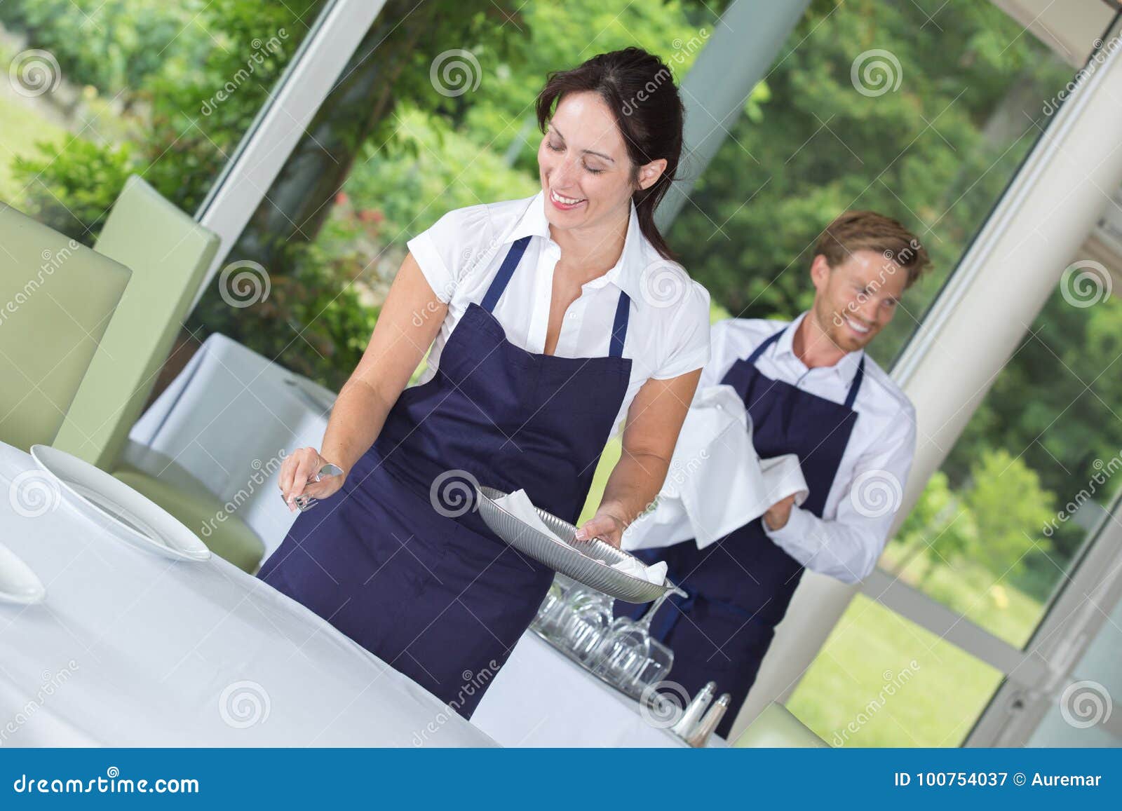 Smiling Waitress Setting Table in Restaurant Stock Image - Image of ...