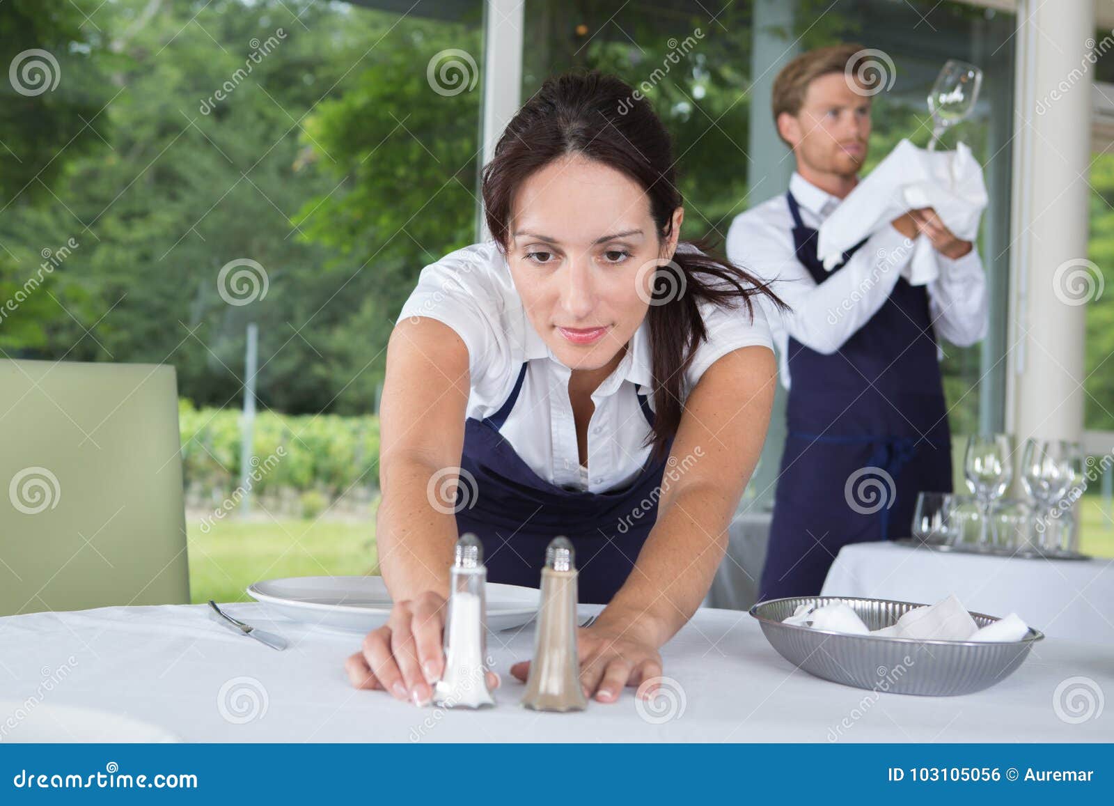 Smiling Waitress Setting Table in Restaurant Stock Photo - Image of ...