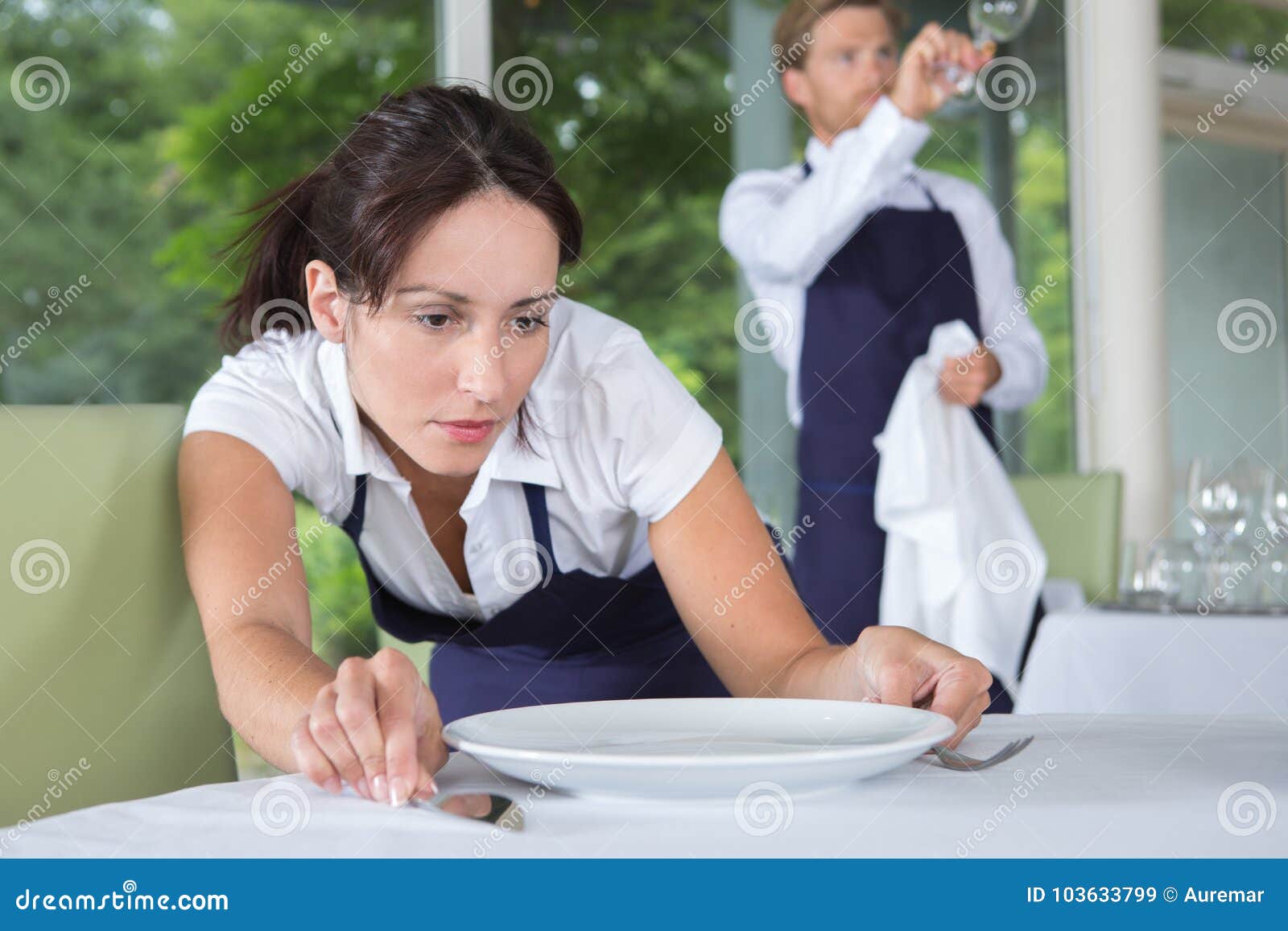 Smiling Waitress Setting Table in Restaurant Stock Image - Image of ...