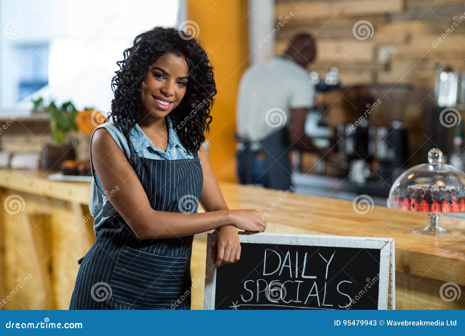 Smiling Waitress Standing with Menu Board in Cafe Stock Image - Image ...