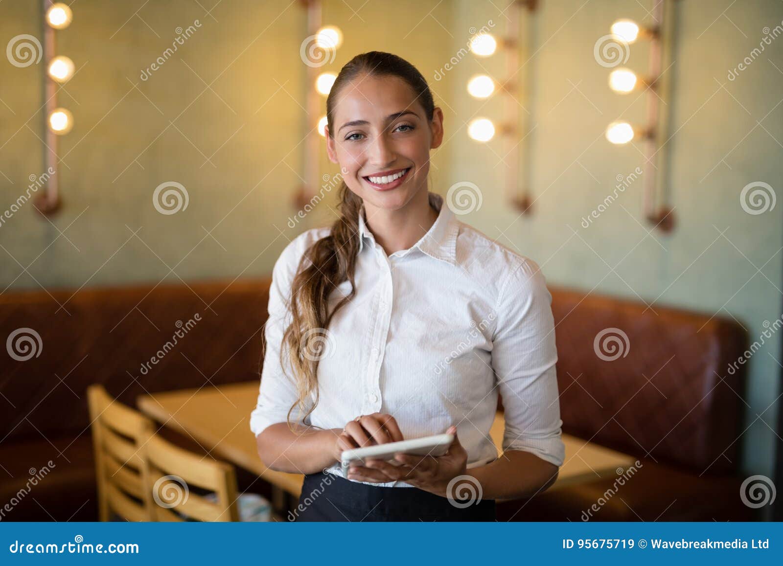 Smiling Waitress Using Digital Tablet in Bar Stock Image - Image of ...