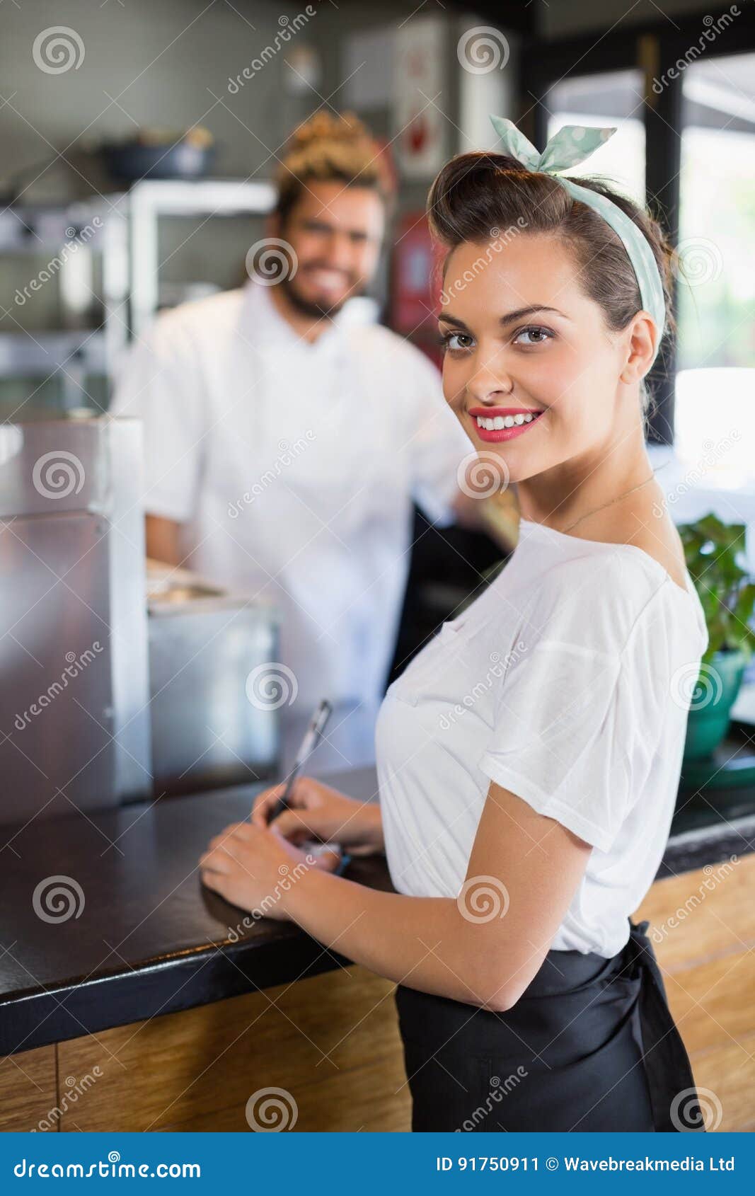 Smiling Waitress Writing on Notepad in Kitchen Stock Image - Image of ...