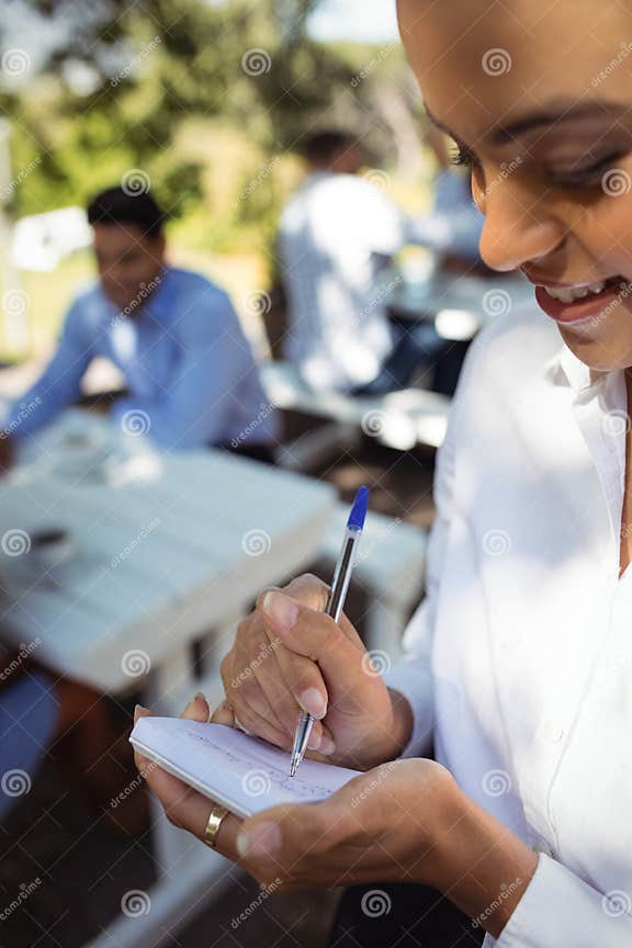 Smiling Waitress Writing Order on Notepad Stock Image - Image of people ...