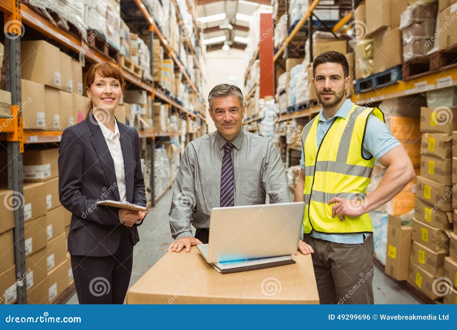 Smiling Warehouse Team Working Together on Laptop Stock Photo - Image ... Smiling Warehouse Team Working Together on Laptop Stock Photo - Image ...