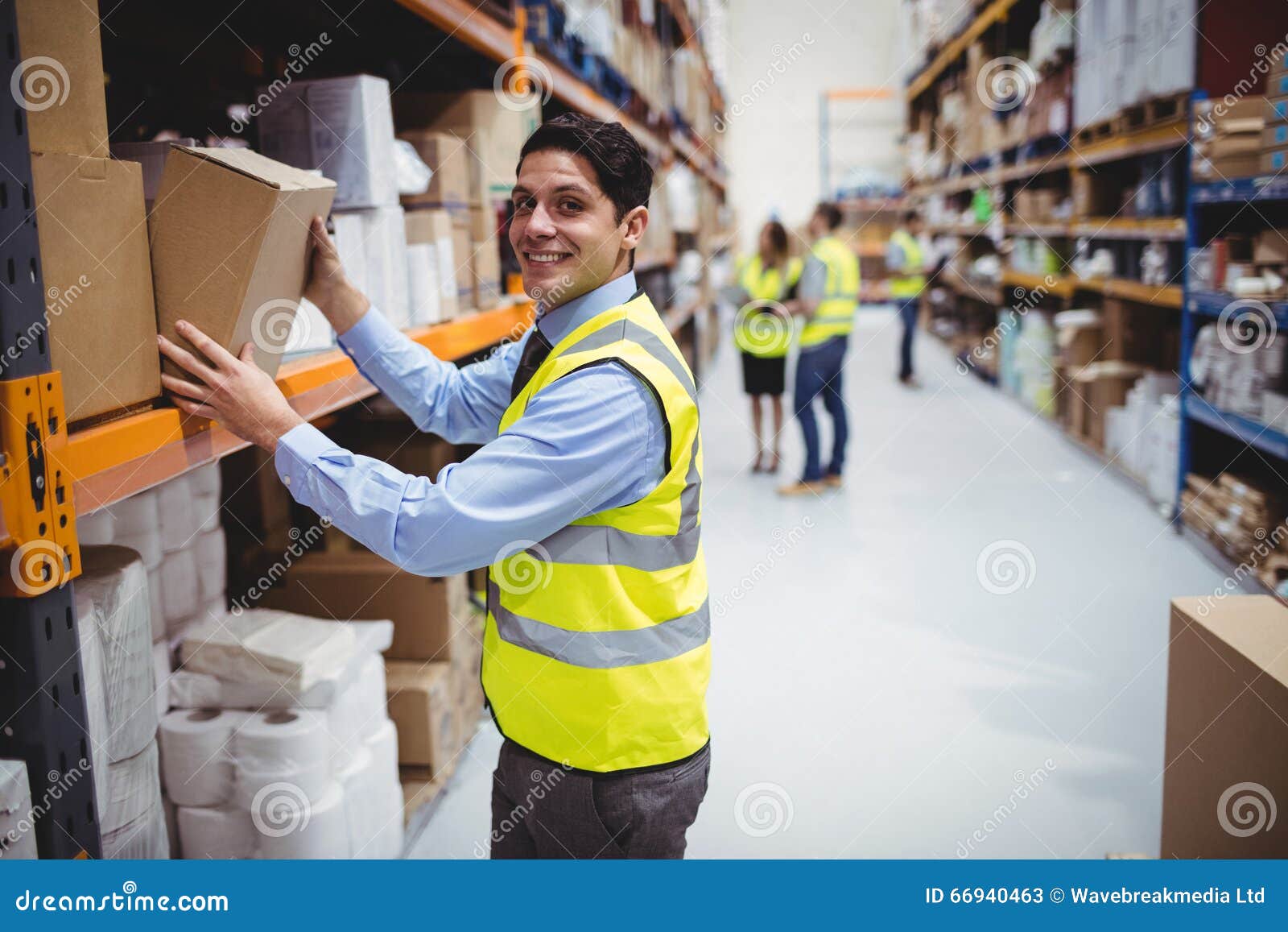 Smiling Warehouse Worker Taking Package in the Shelf Stock Image ...
