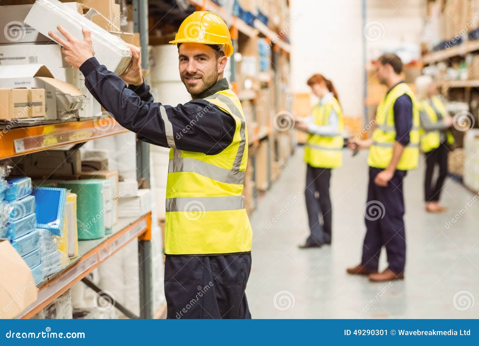 Smiling Warehouse Worker Taking Package In The Shelf Stock Photo ...