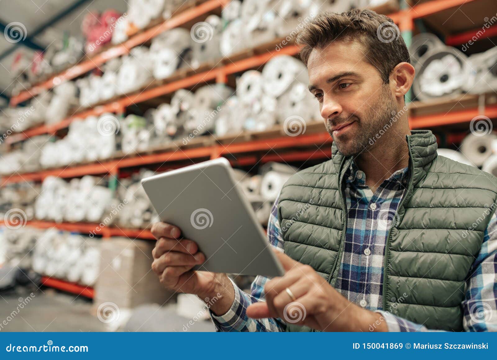 Smiling Warehouse Worker Using a Digital Tablet To Trace Stock Stock ...