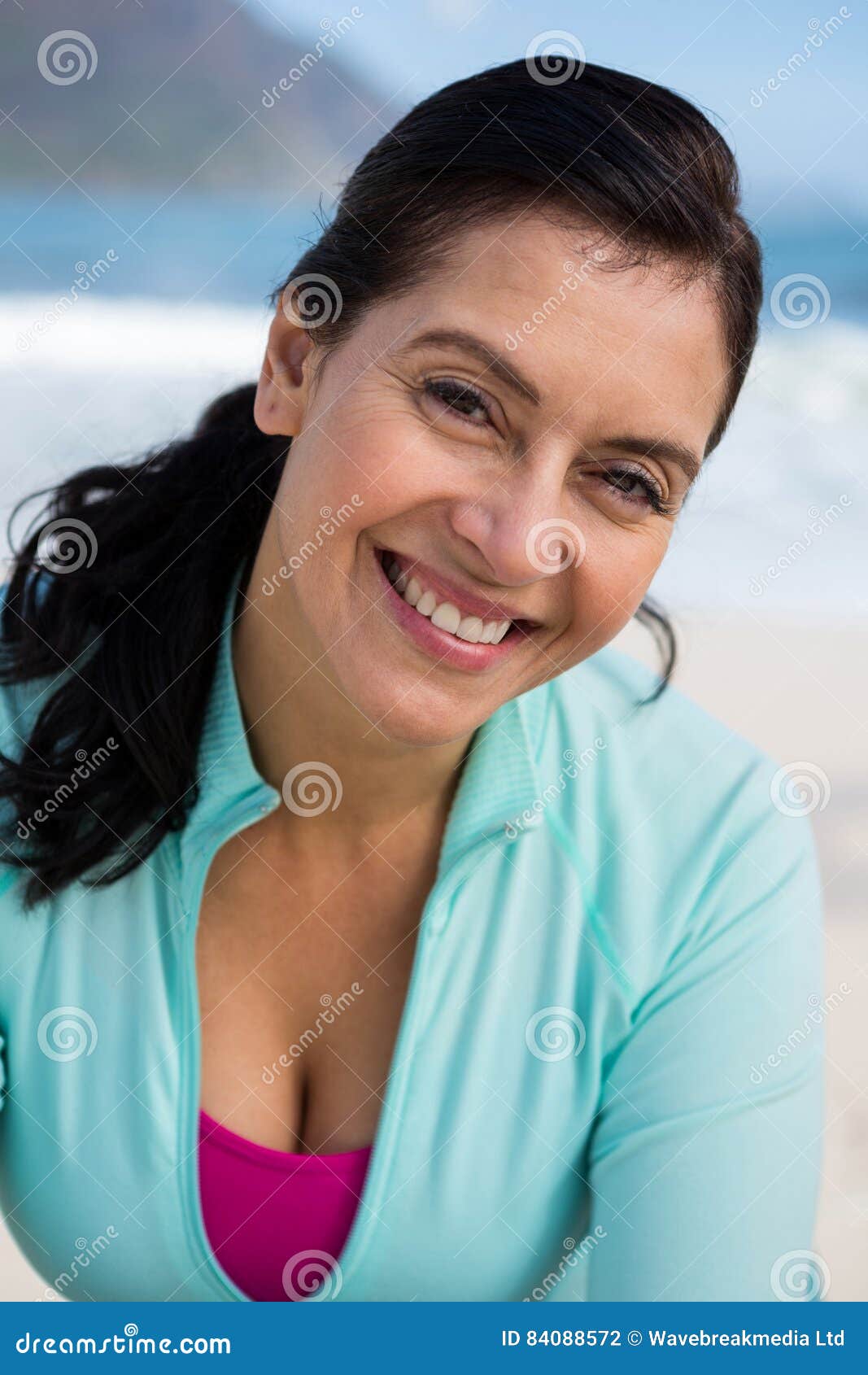 Smiling woman at the beach stock photo. Image of cheerful - 84088572