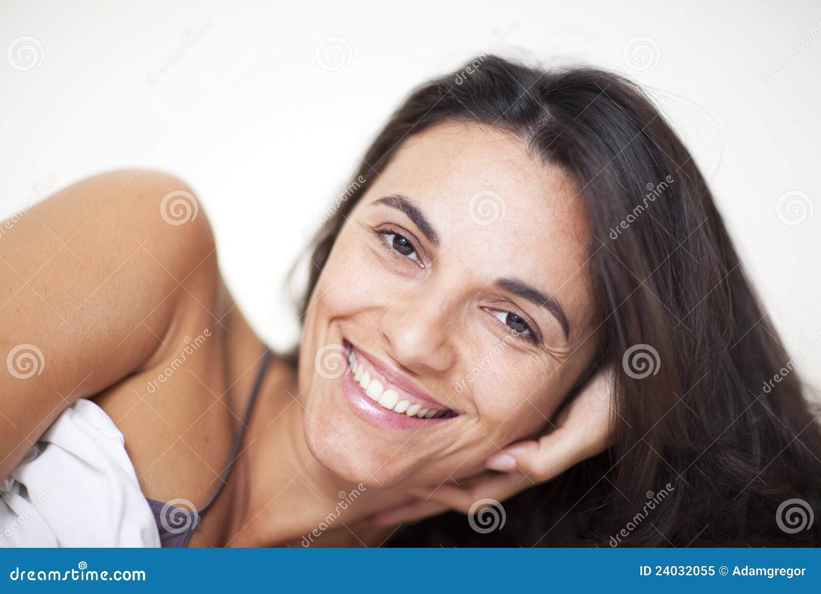 Smiling woman in bed stock image. Image of brunette, adult - 24032055