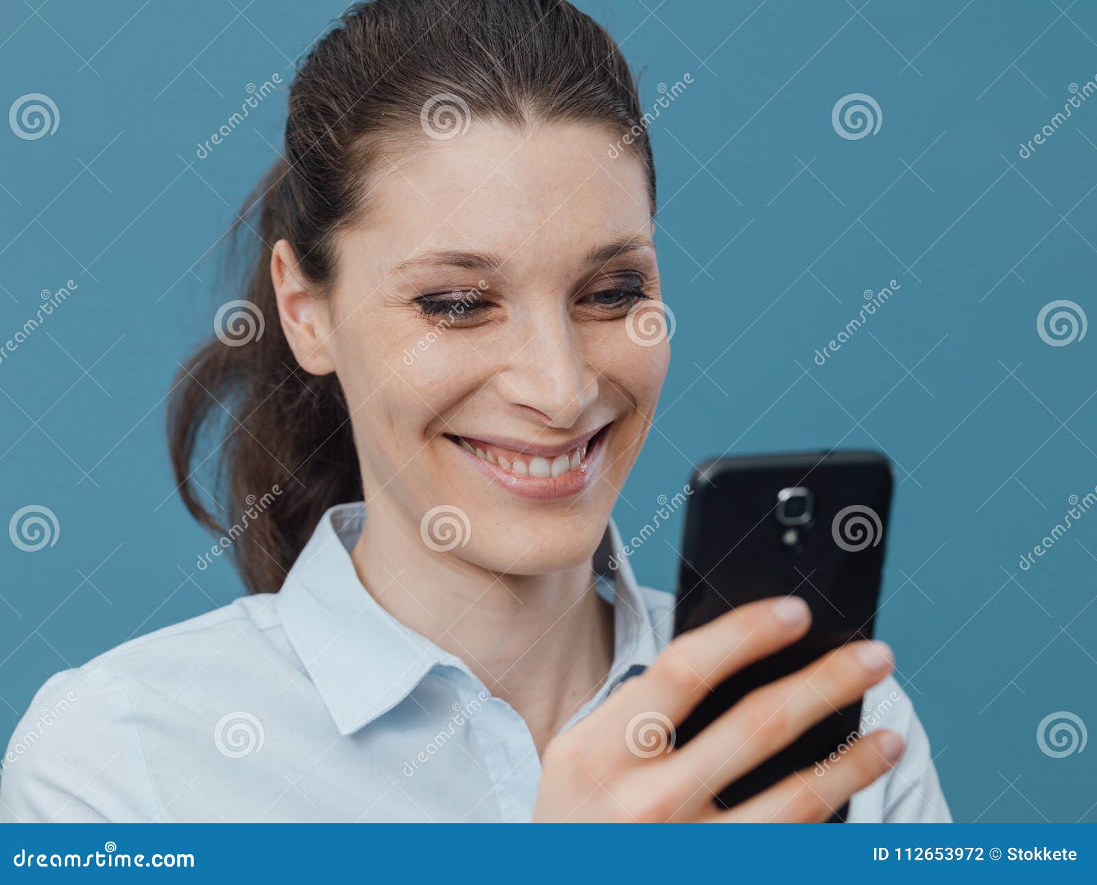 Smiling Woman Connecting with Her Smartphone Stock Photo - Image of ... Smiling Woman Connecting with Her Smartphone Stock Photo - Image of ...