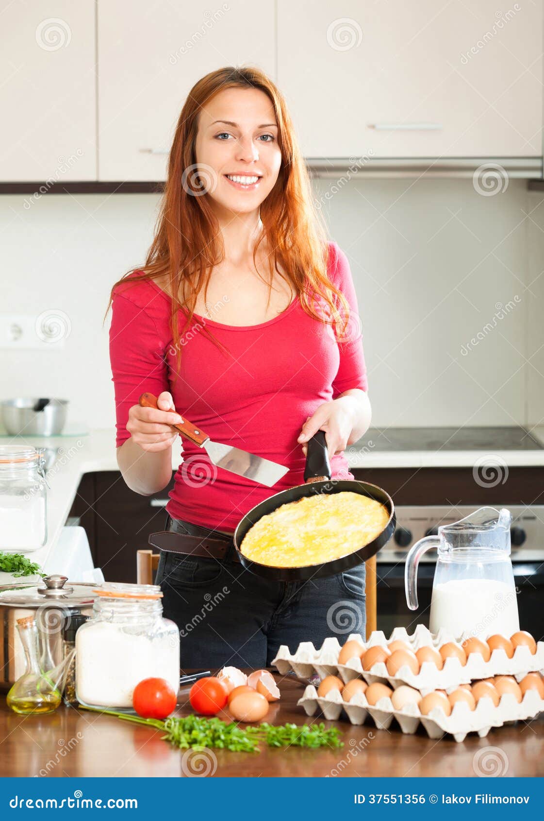 Smiling Woman Cooking Scrambled Eggs in Home Kitchen Stock Photo ...