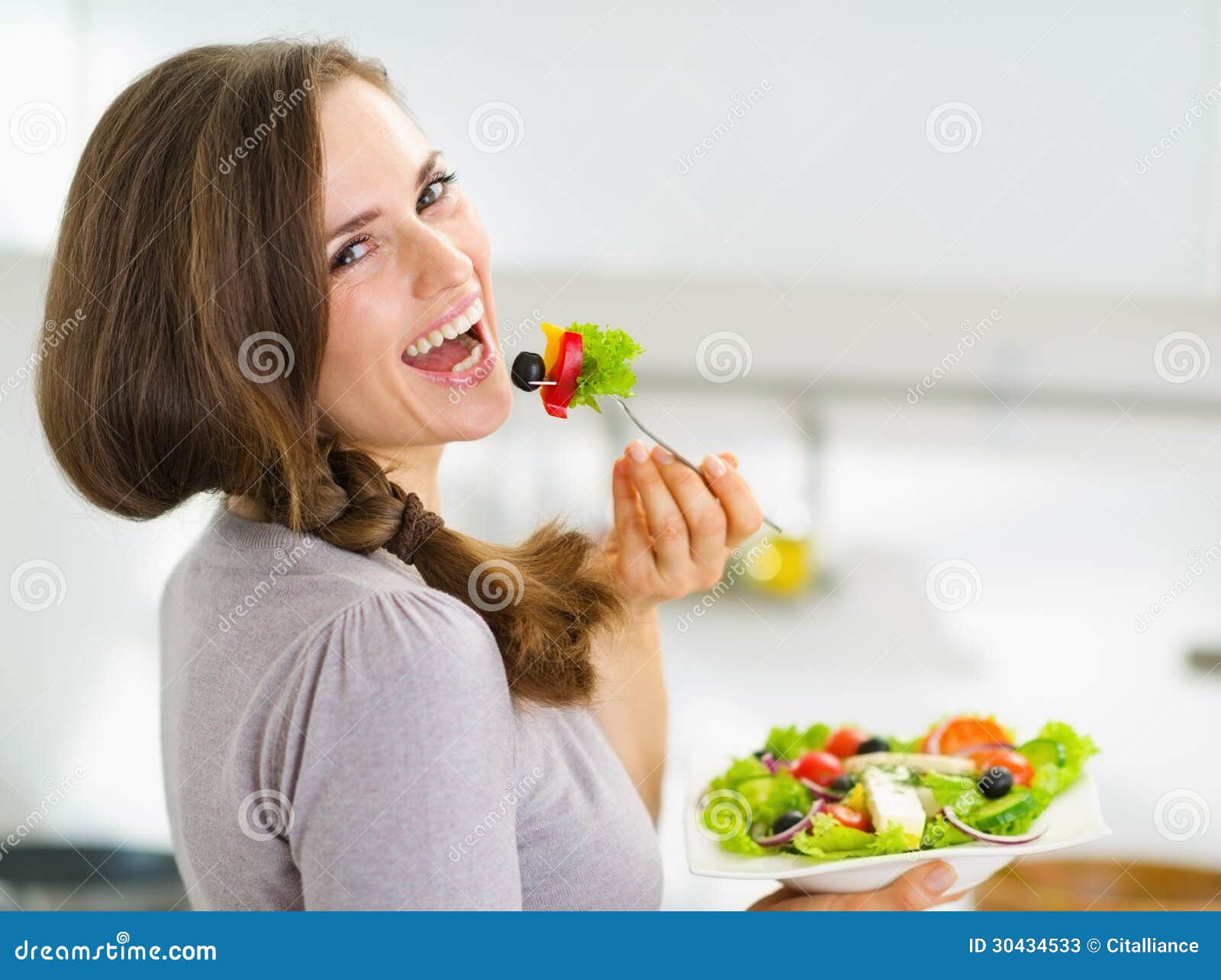 Smiling Woman Eating Fresh Salad in Kitchen Stock Image - Image of ...
